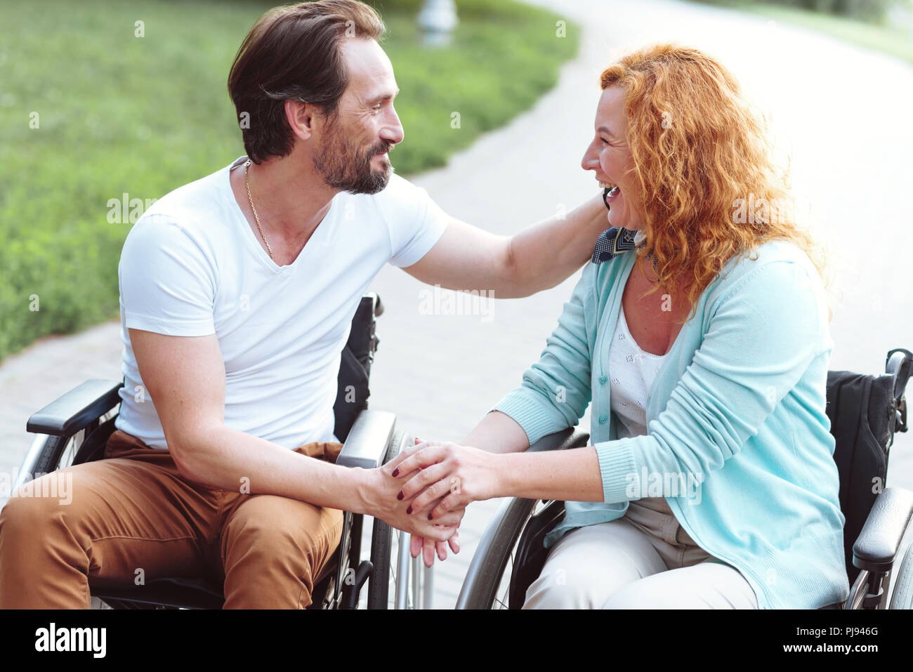 Emotional disabled couple smiling and embracing outdoors Stock Photo ...