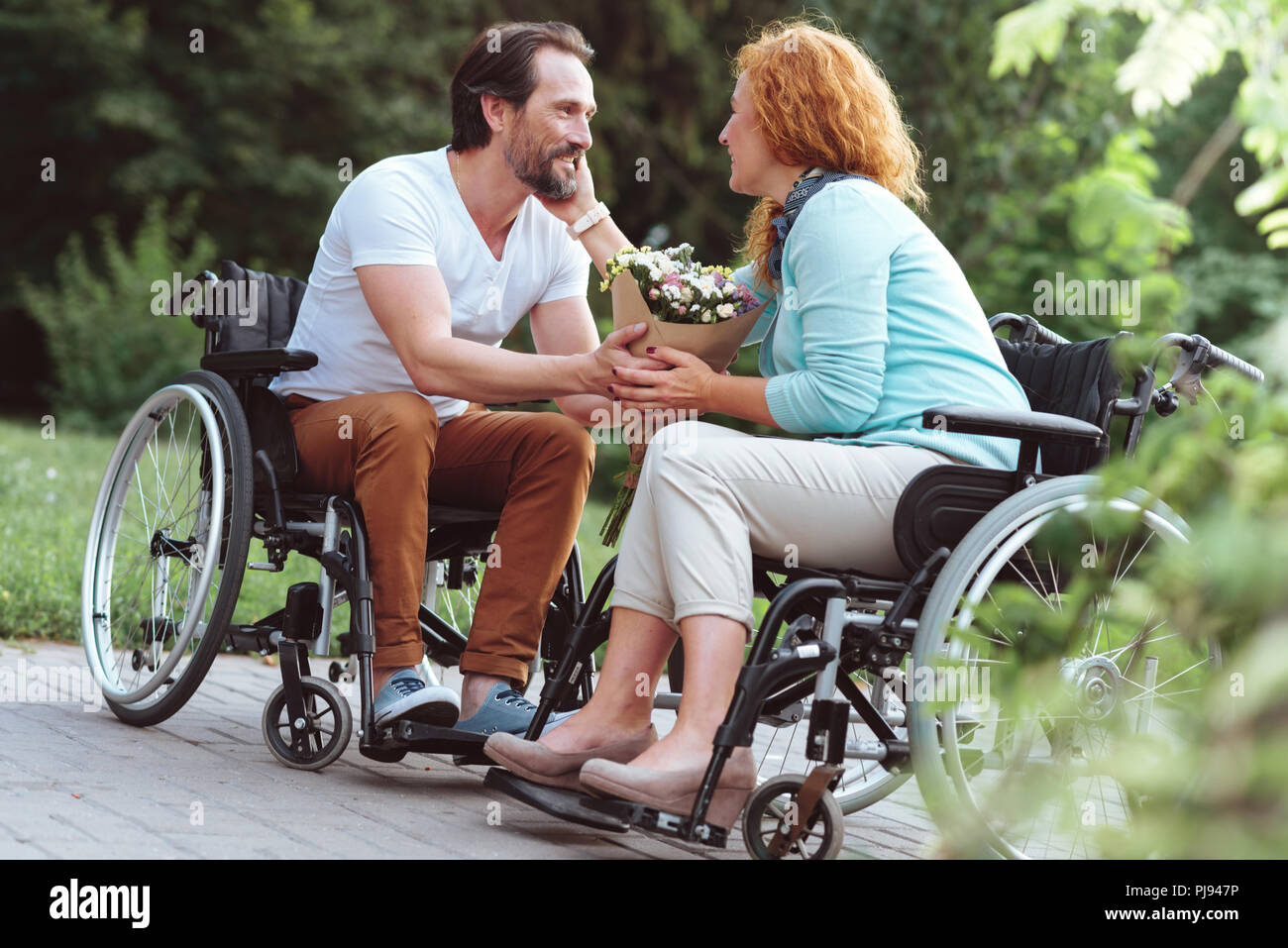 Adorable disabled couple going on date outdoors Stock Photo - Alamy