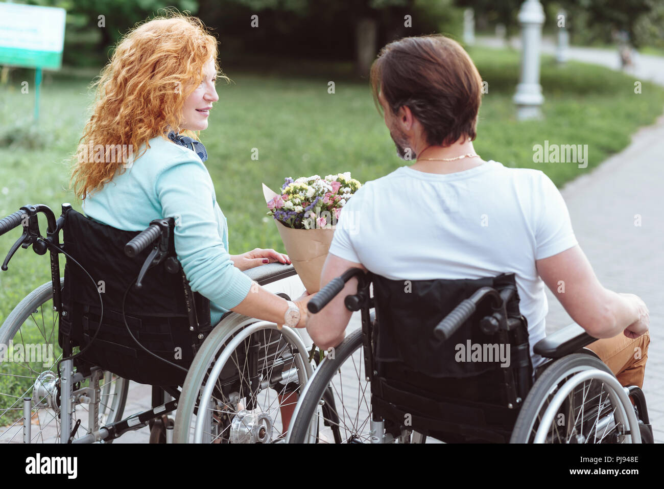 Incapacitated husband and wife holding flowers together Stock Photo - Alamy