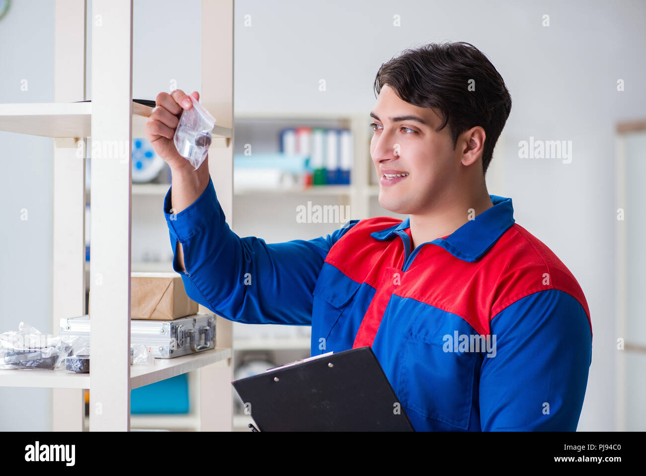 Man working in the postal warehouse Stock Photo - Alamy