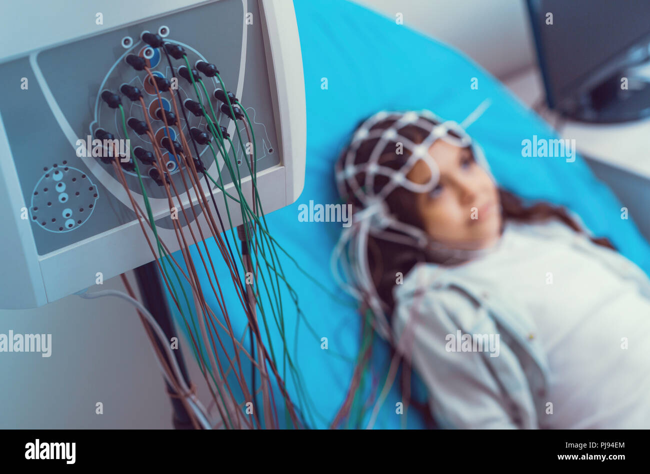 Poor little girl getting her brain analyzed at laboratory Stock Photo ...