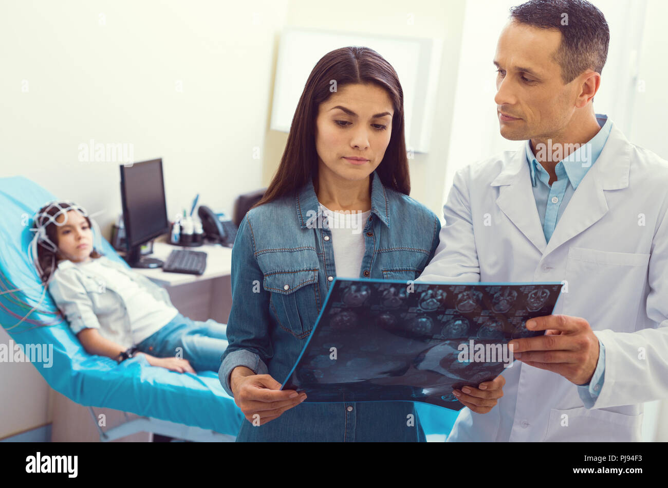 Doctor and parent discussing mri scan of child Stock Photo - Alamy
