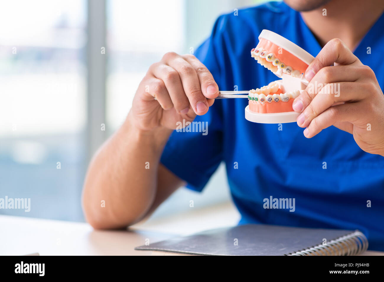 Man dentist working on new teeth implant Stock Photo - Alamy