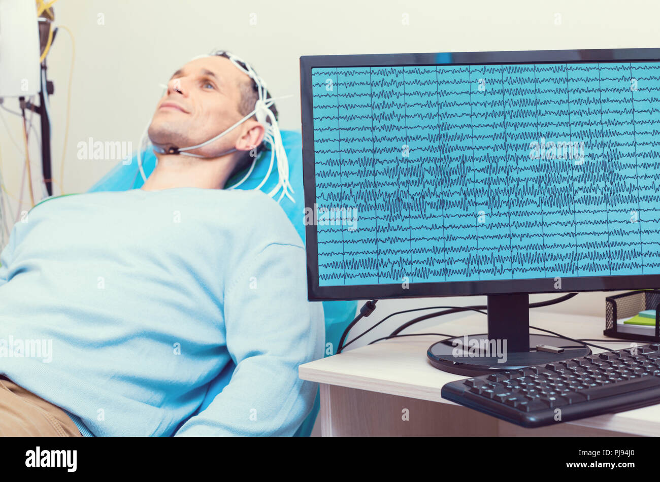 PC displaying brain waves of male patient at lab Stock Photo - Alamy