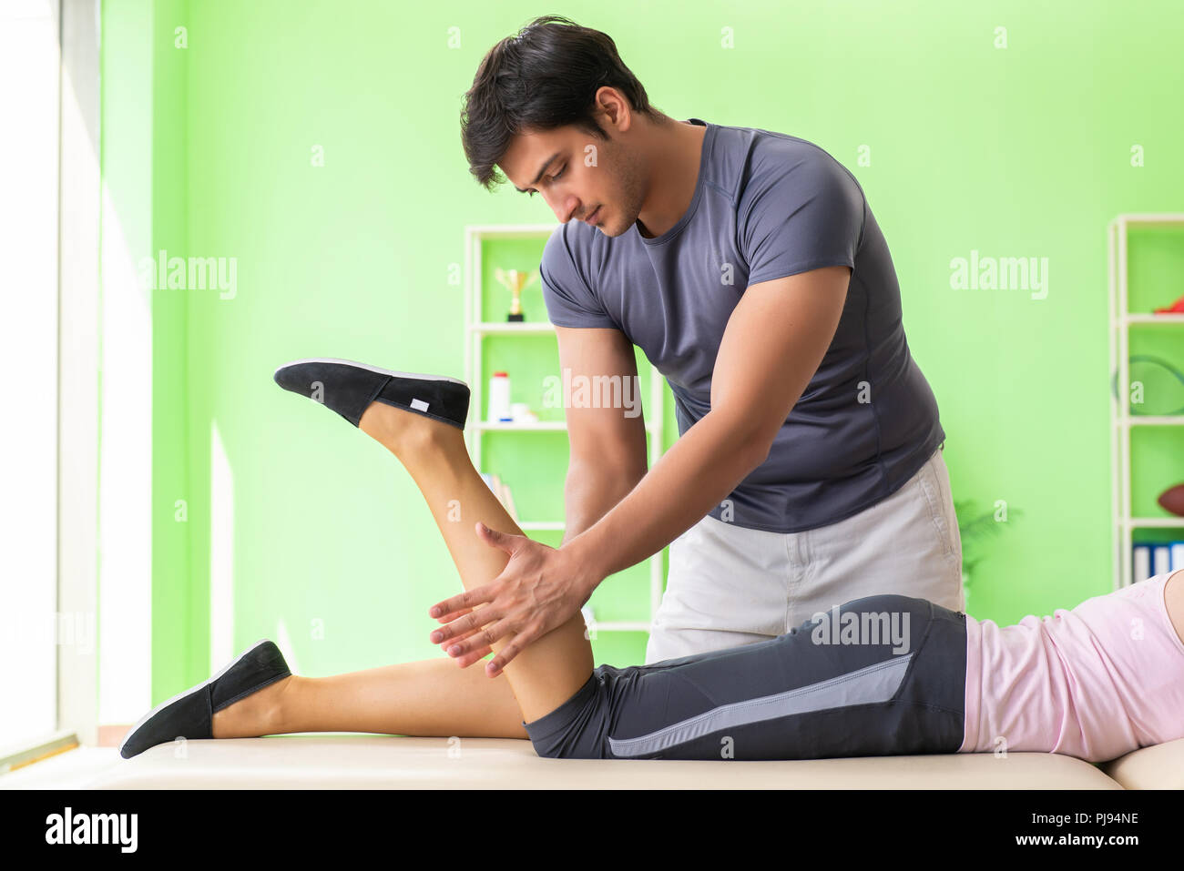 Young doctor chiropractor massaging patient Stock Photo - Alamy