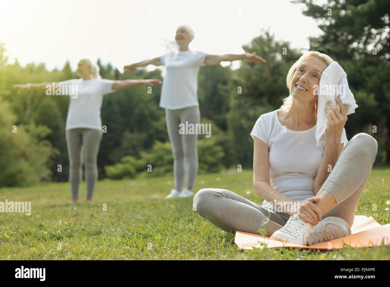 Happy elderly lady resting after intensive training Stock Photo - Alamy