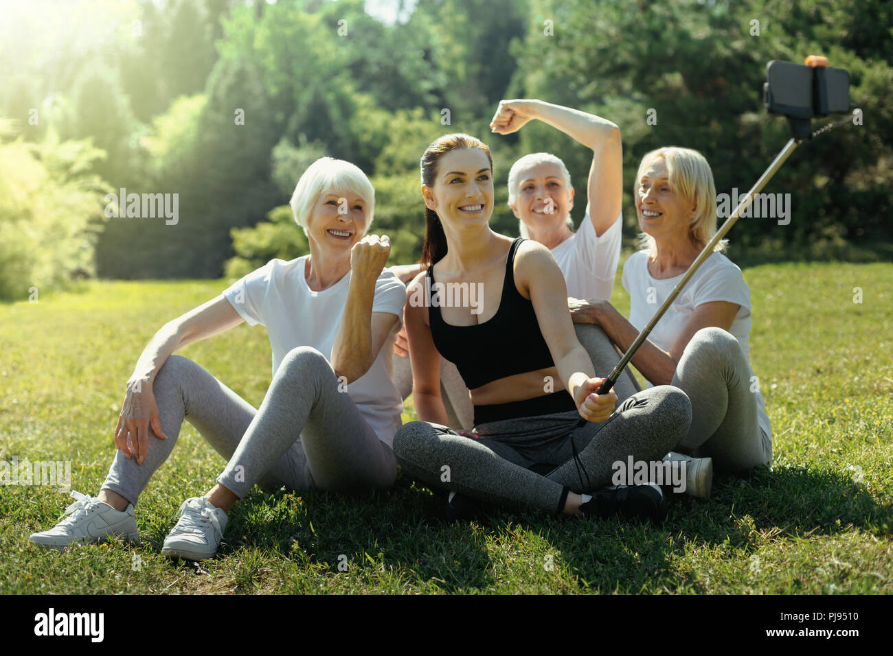 Excited retired people and trainer taking selfie together Stock Photo ...