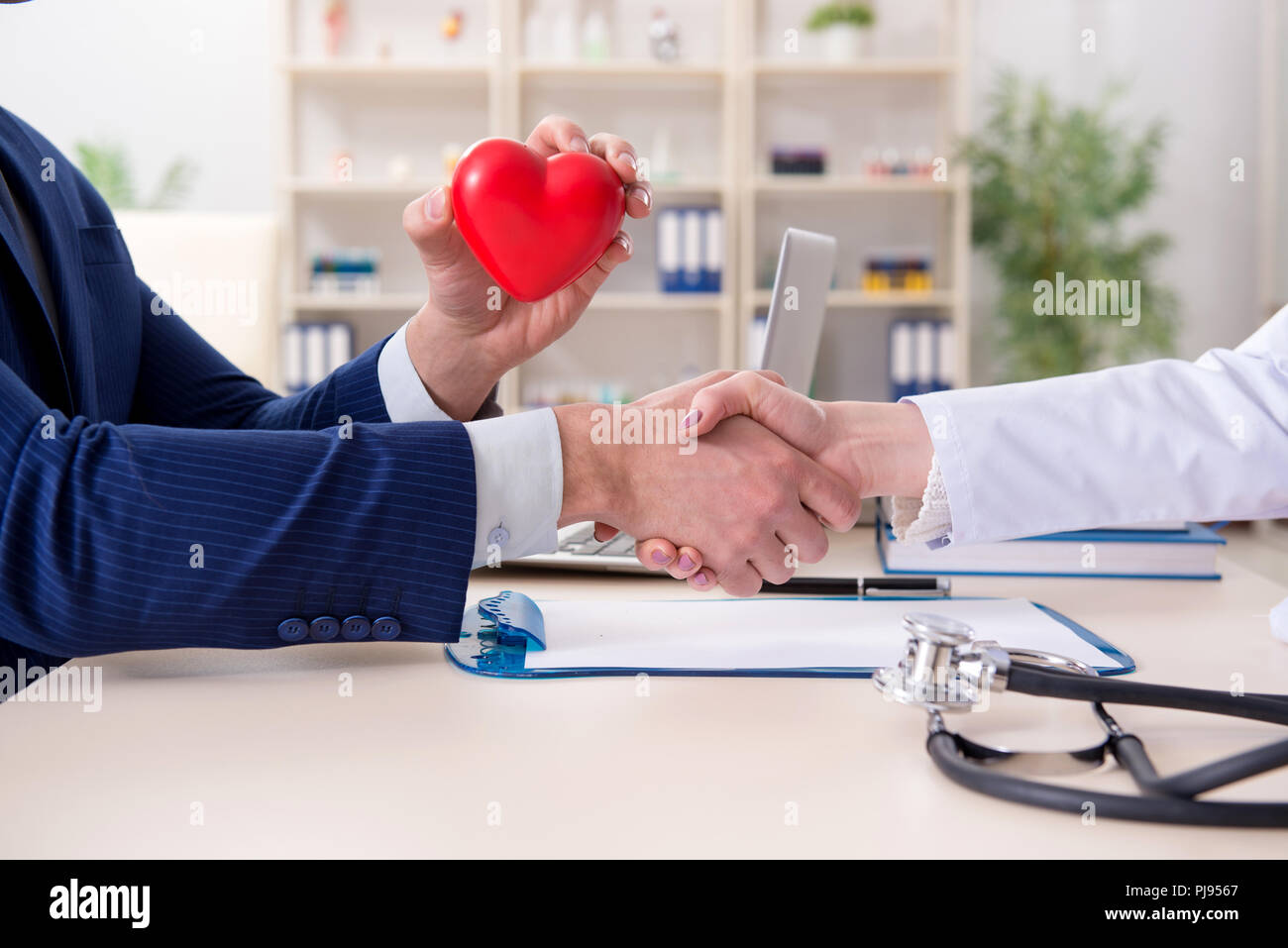Businessman visiting cardiologist for routine check-up Stock Photo - Alamy