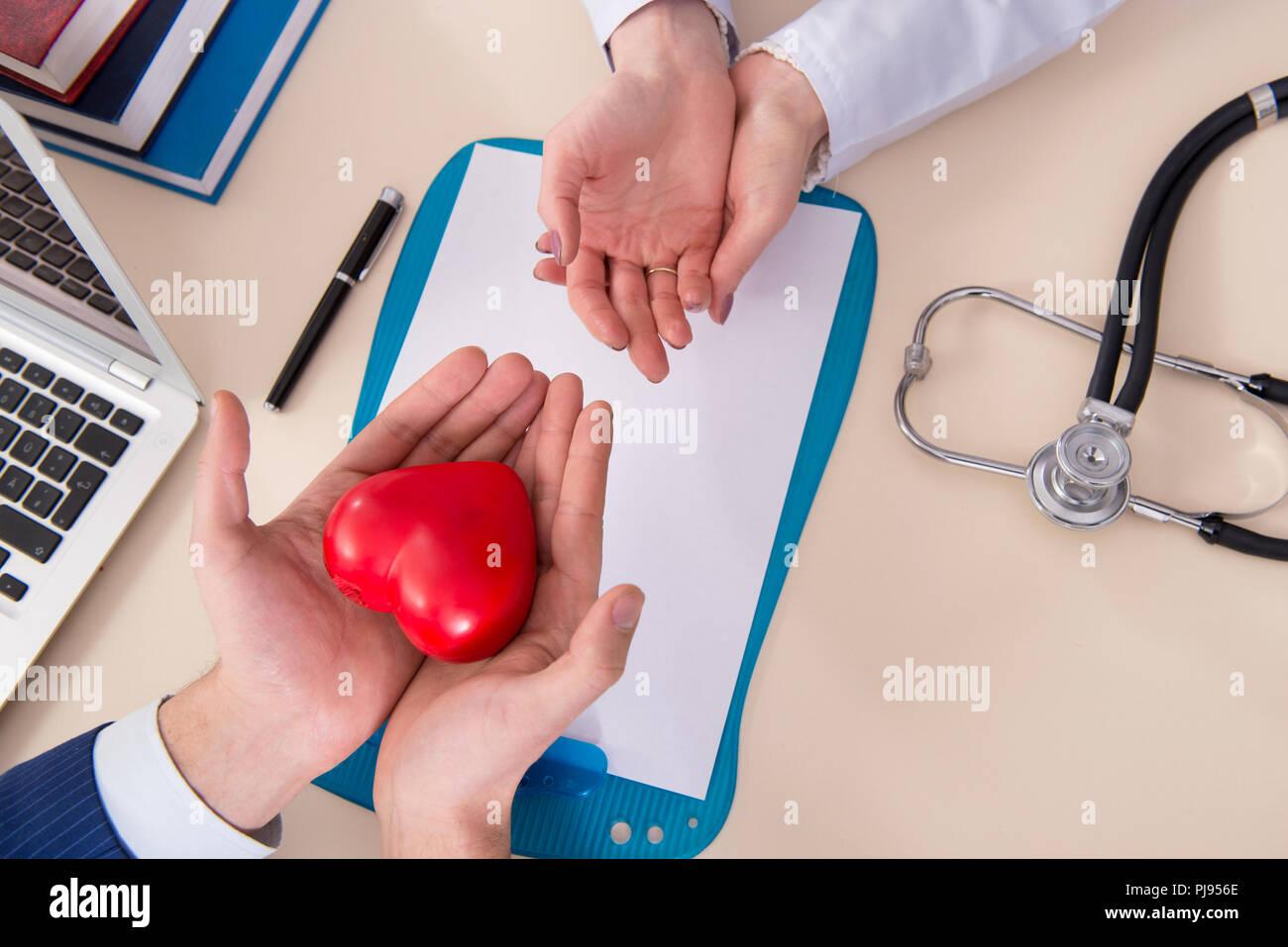 Businessman visiting cardiologist for routine check-up Stock Photo - Alamy