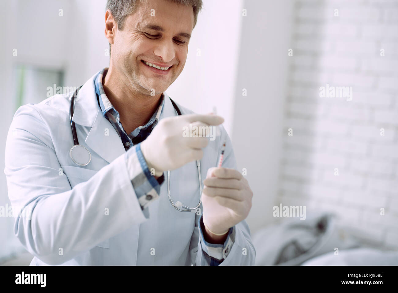 Happy cheerful doctor smiling Stock Photo - Alamy