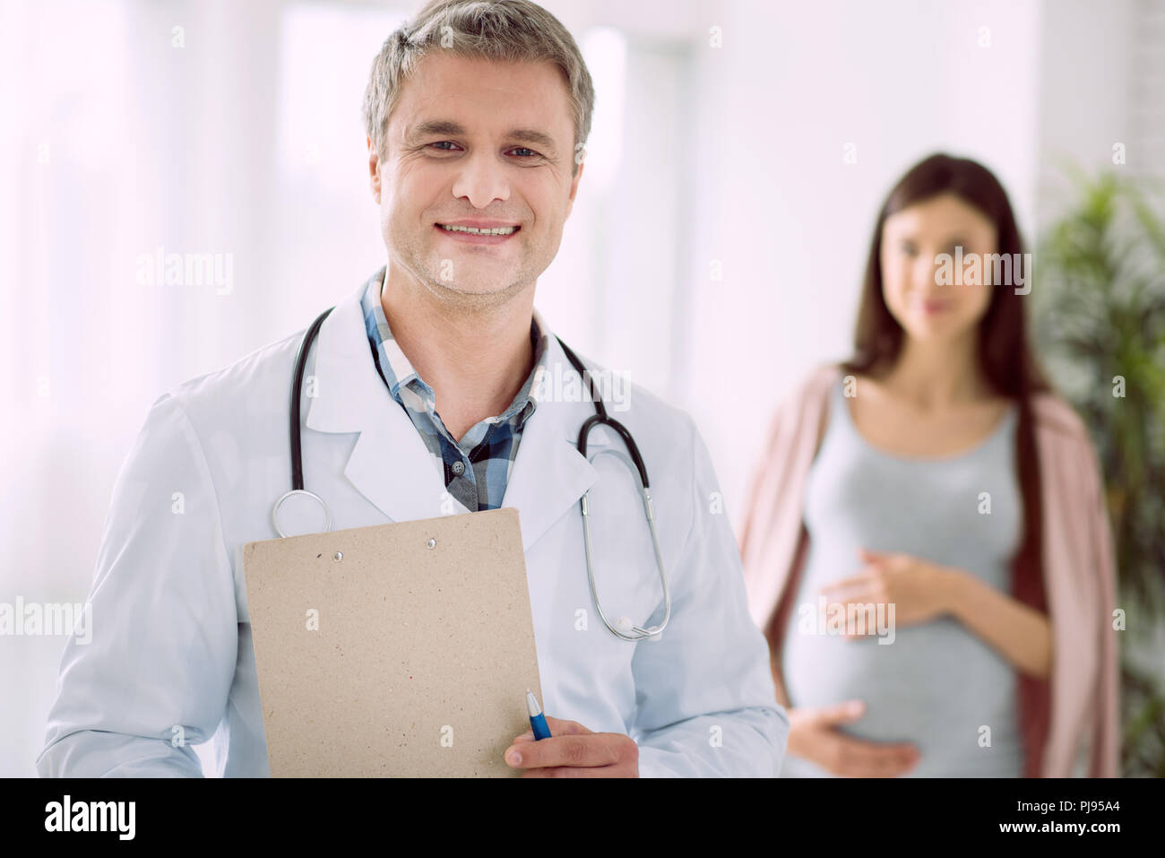 Professional smart doctor holding his notes Stock Photo - Alamy