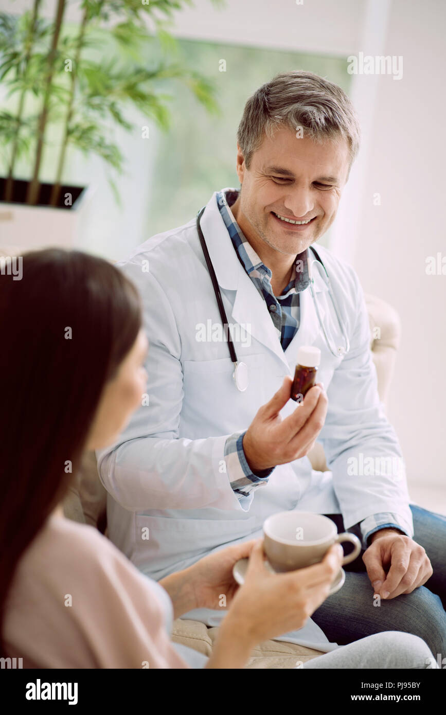 Happy cheerful doctor prescribing medicine Stock Photo - Alamy