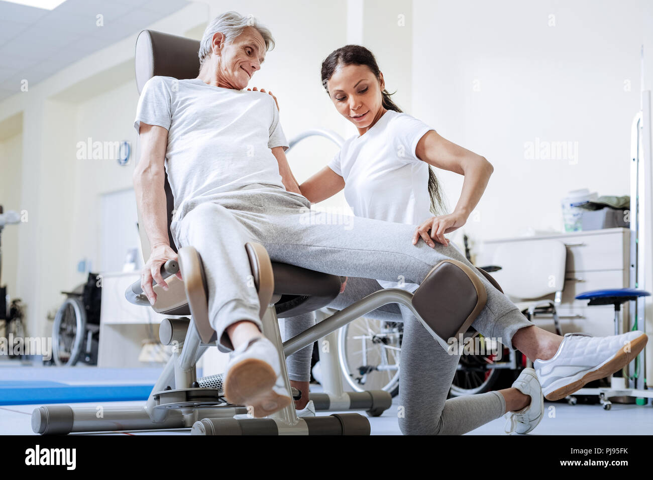 Smart qualified doctor curing her aged patient and feeling confident ...