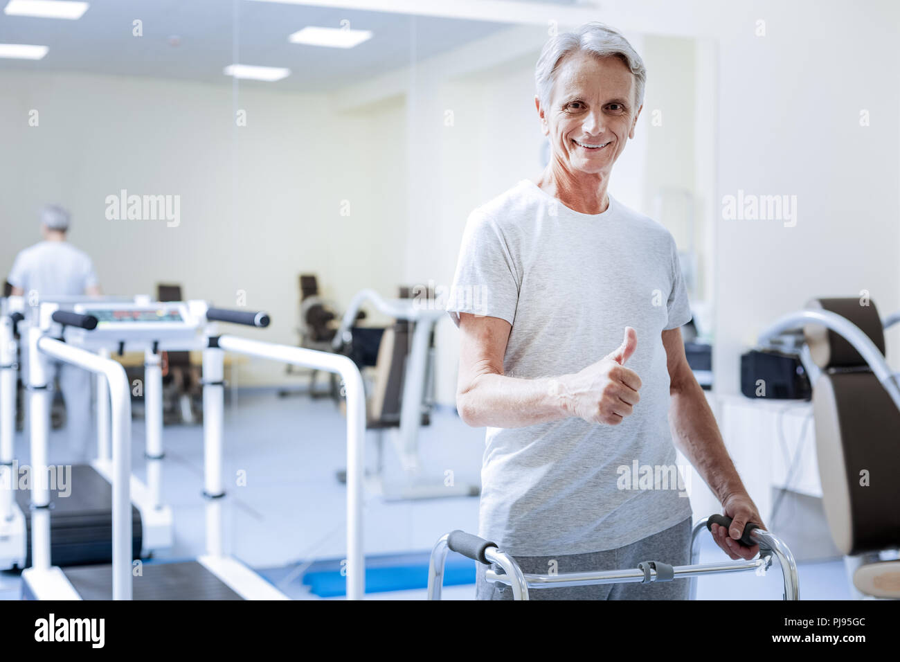 Positive aged man feeling better while being in a rehabilitation center ...