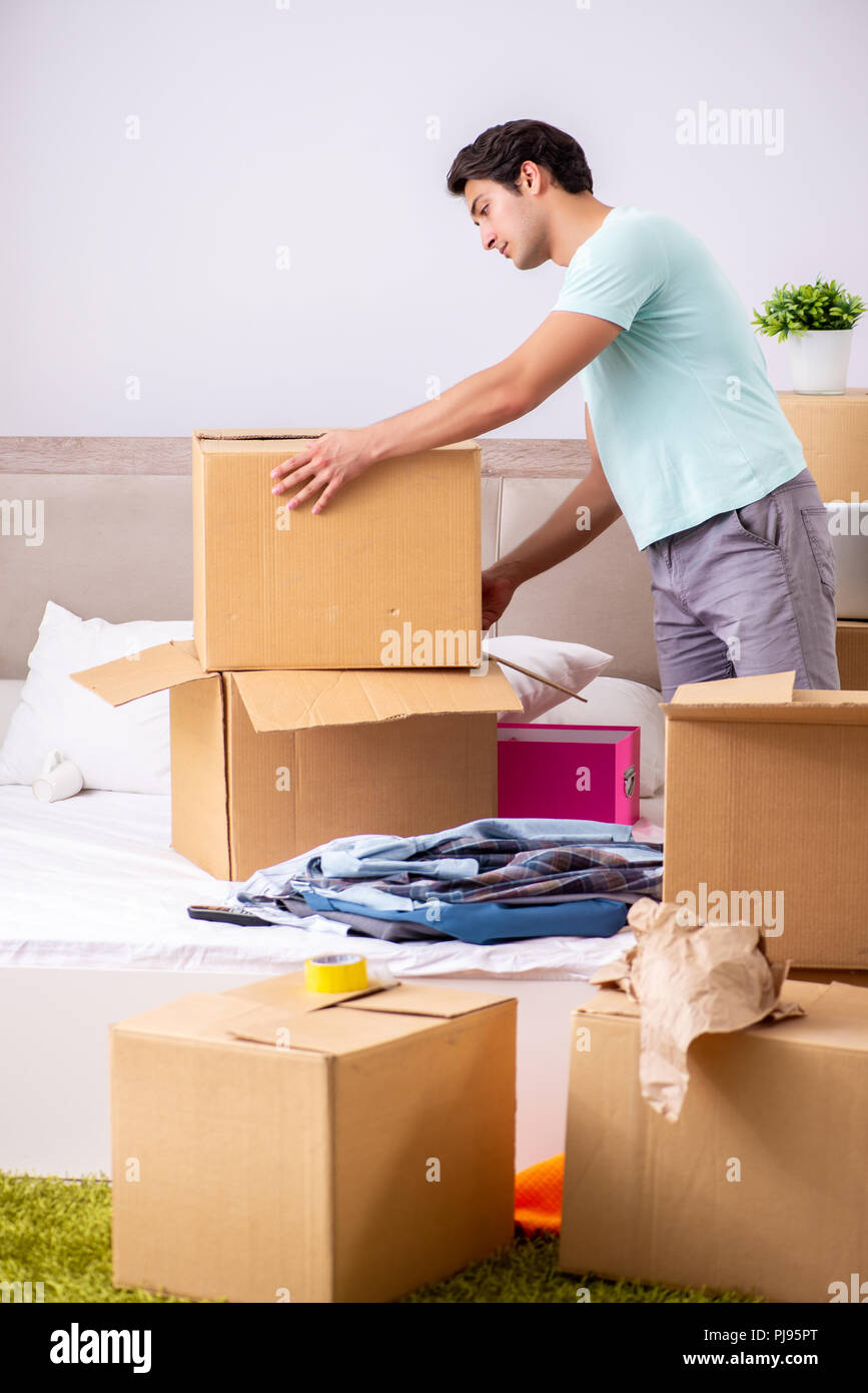 Young man moving to new apartment Stock Photo - Alamy