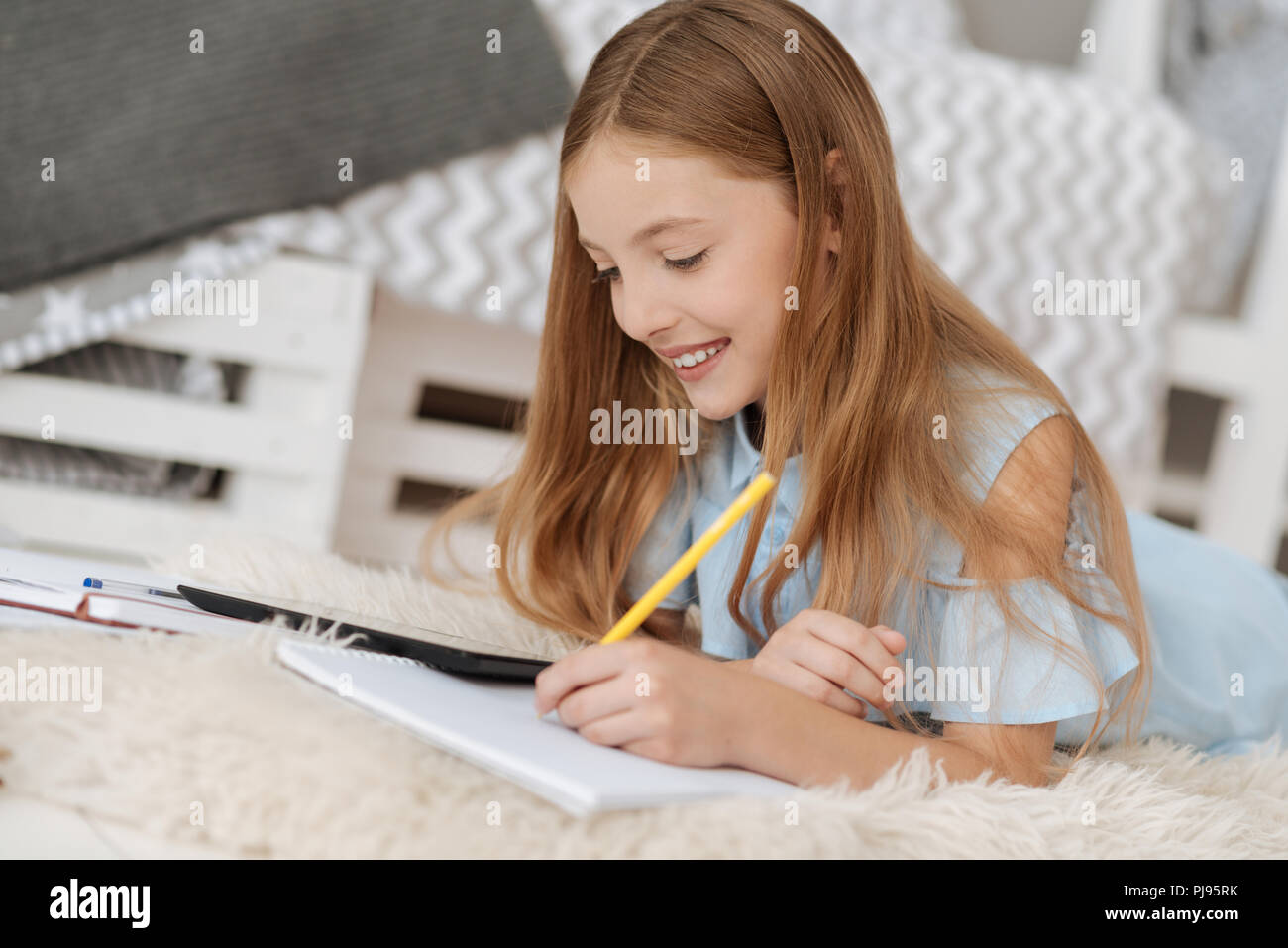 Schoolgirl writing in exercise hi-res stock photography and images - Alamy