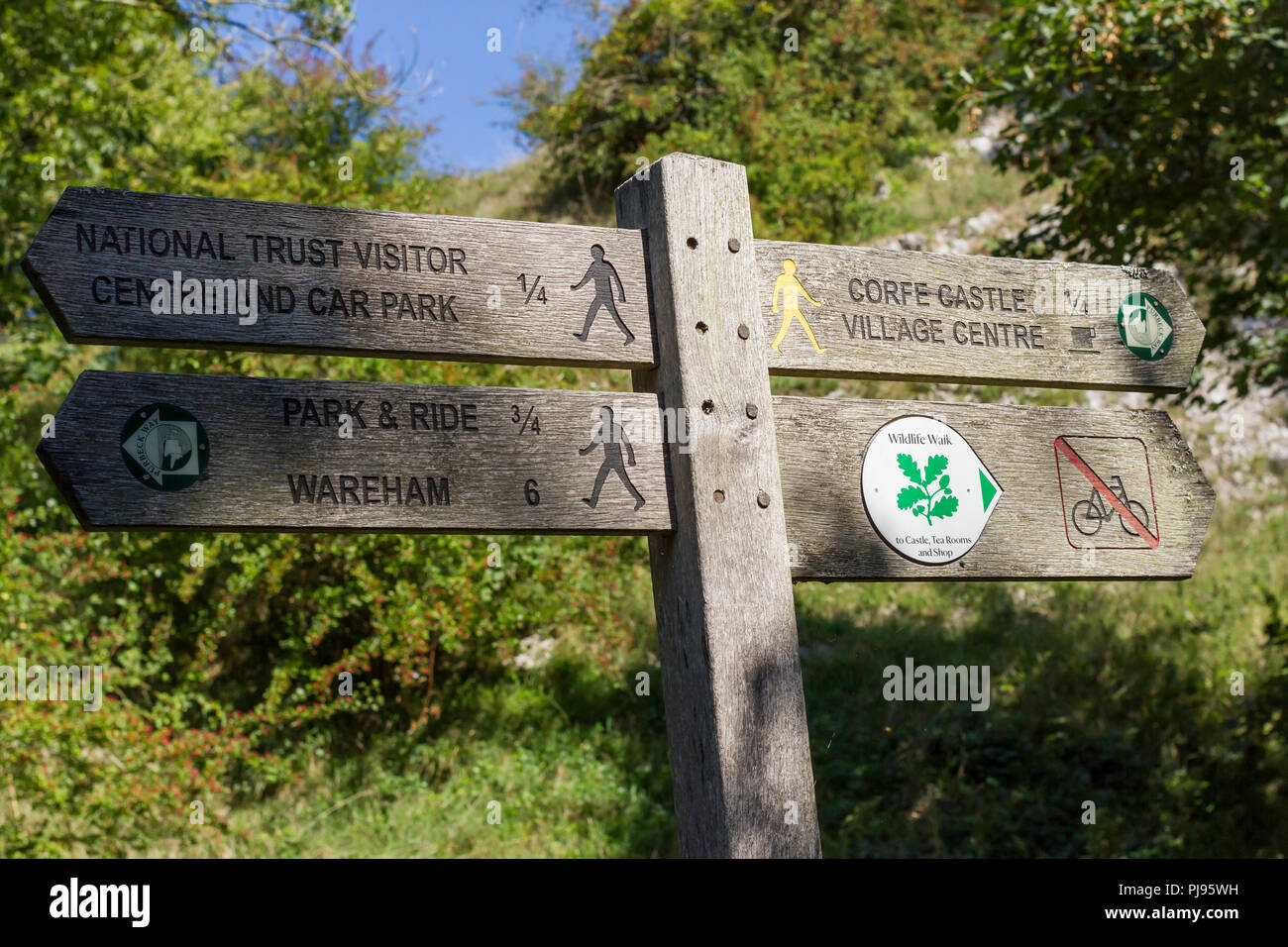 Wooden signpost, Corfe Castle, Dorset, England, UK Stock Photo - Alamy