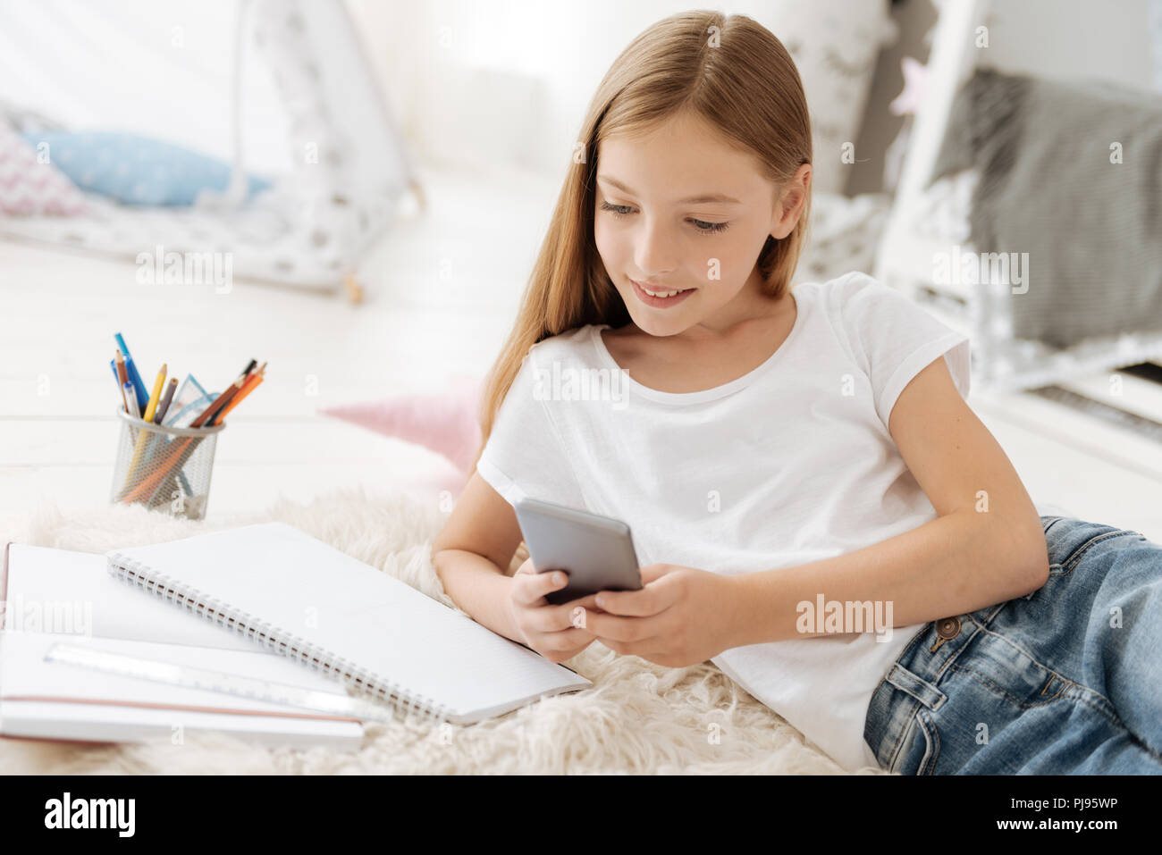 Concentrated blonde girl typing message Stock Photo - Alamy