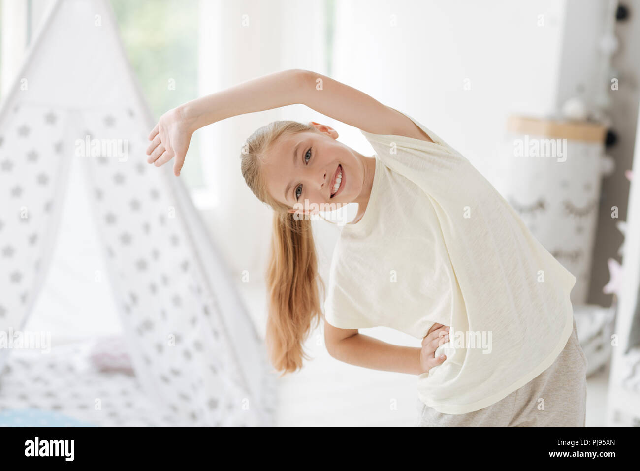 Happy girl stretching her back Stock Photo - Alamy