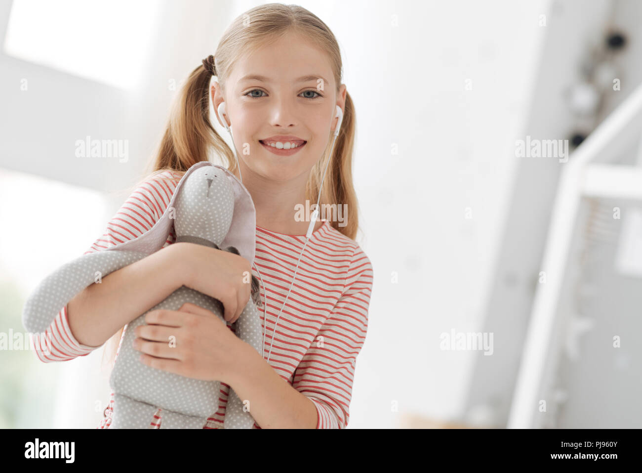 Amazing child embracing her toy Stock Photo - Alamy