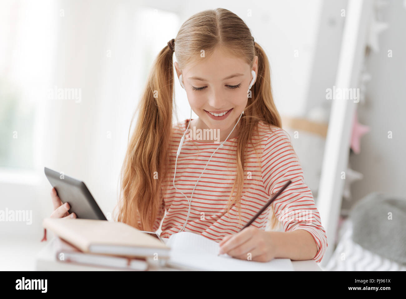 Positive delighted girl doing home tasks Stock Photo - Alamy