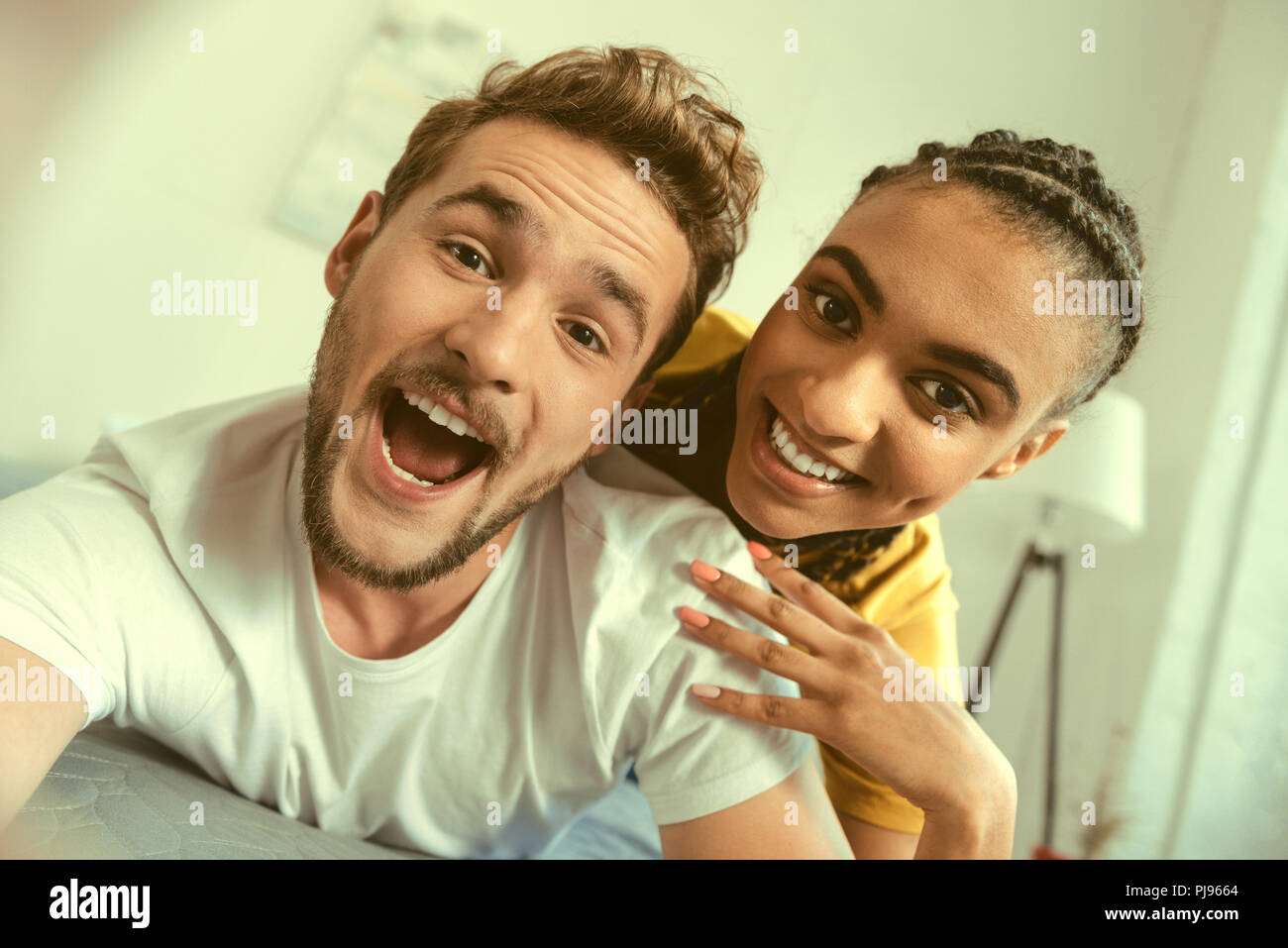 Positive minded couple posing for self portrait at home Stock Photo - Alamy