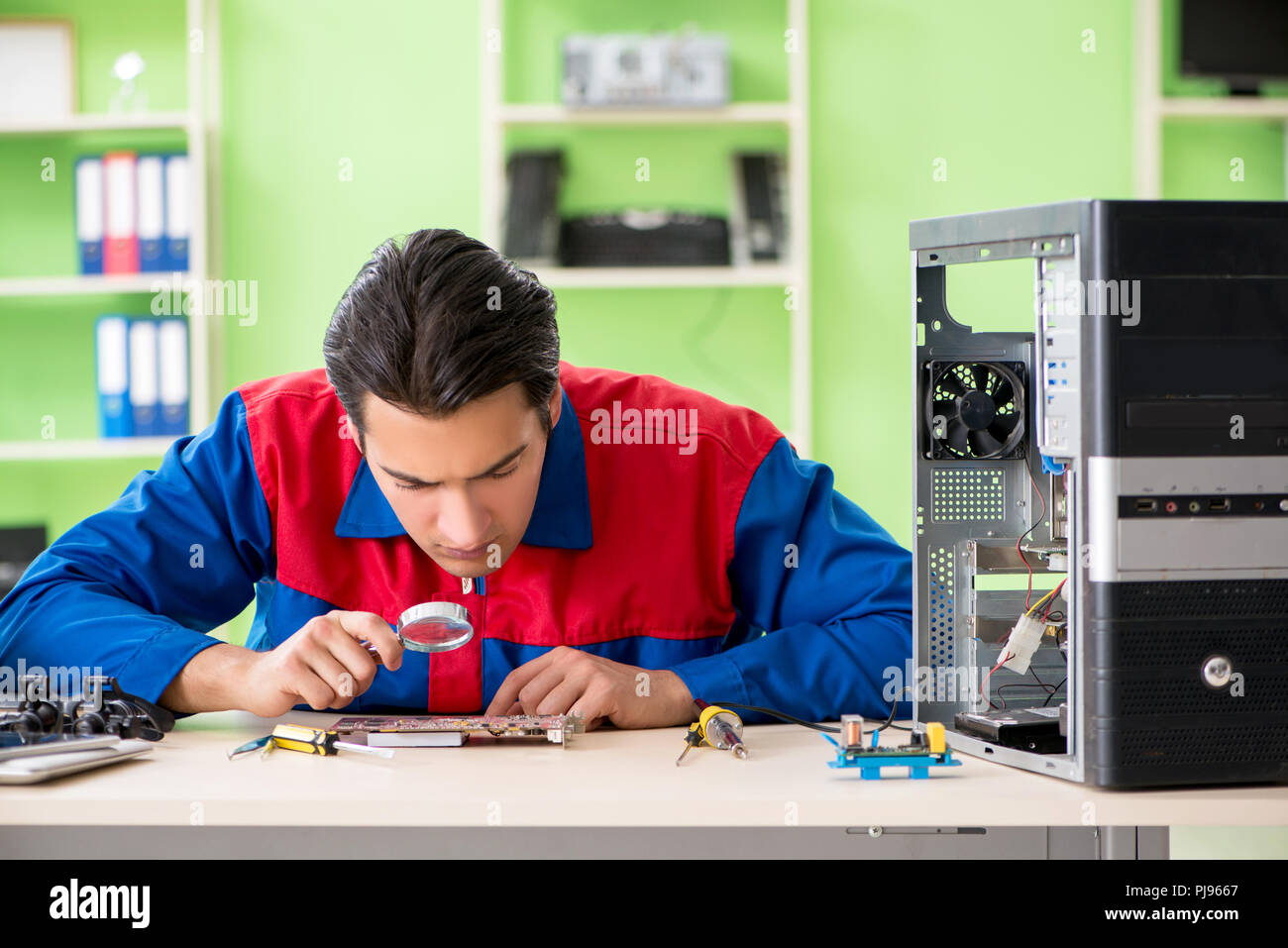 Computer engineer repairing broken desktop Stock Photo - Alamy