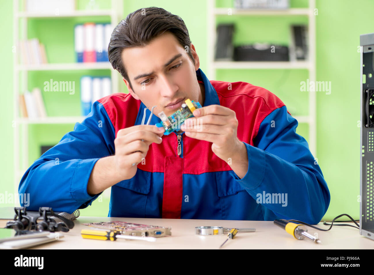 Computer engineer repairing broken desktop Stock Photo - Alamy