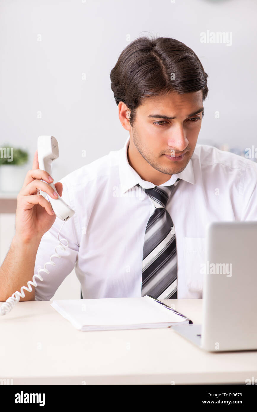 Young call center operator speaking on phone Stock Photo - Alamy