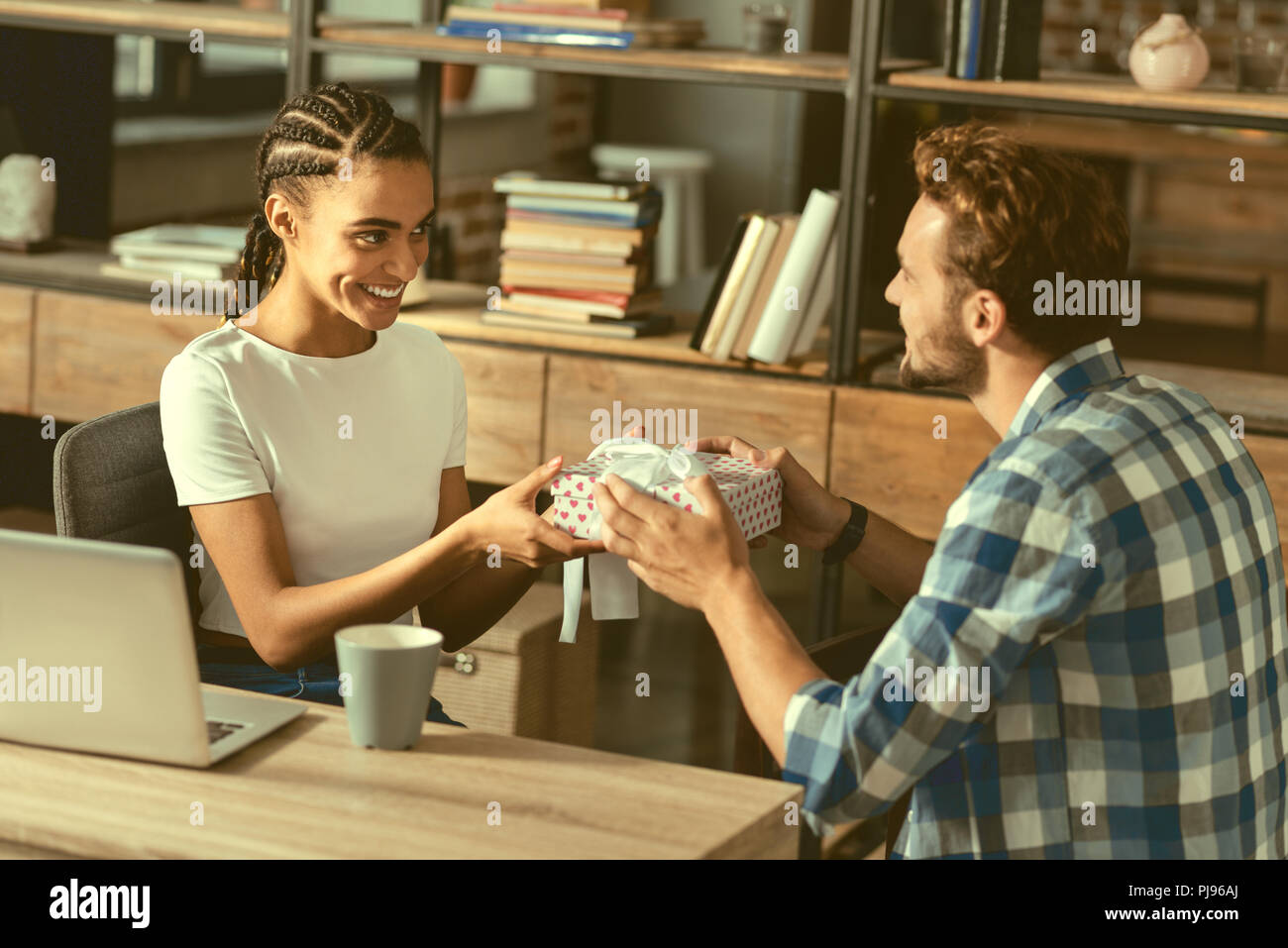 Adorable couple changing gifts while celebrating anniversary Stock ...
