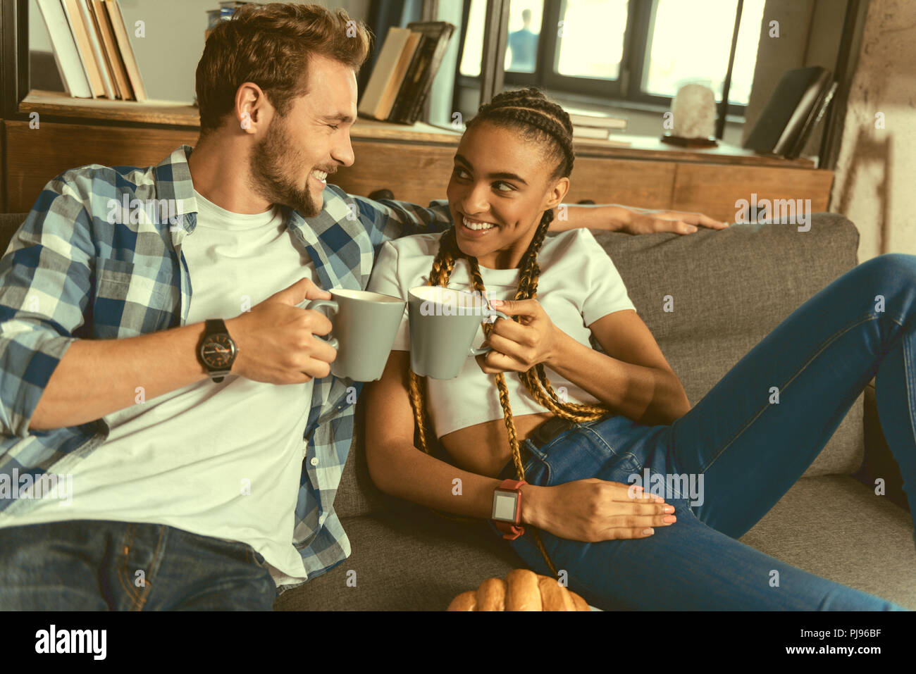 International couple enjoying tea together Stock Photo - Alamy