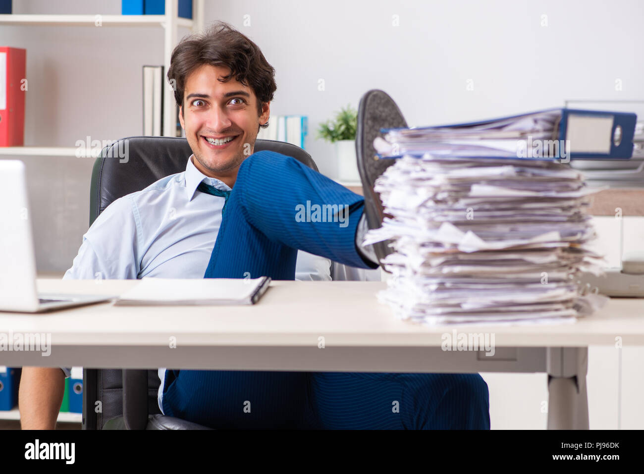 Overloaded busy employee with too much work and paperwork Stock Photo ...