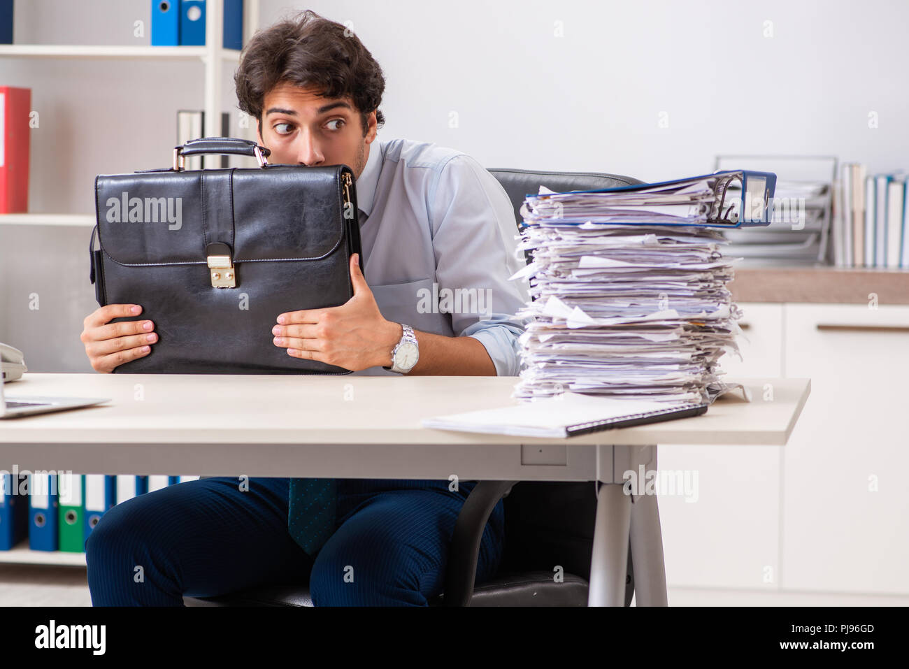 Overloaded busy employee with too much work and paperwork Stock Photo ...
