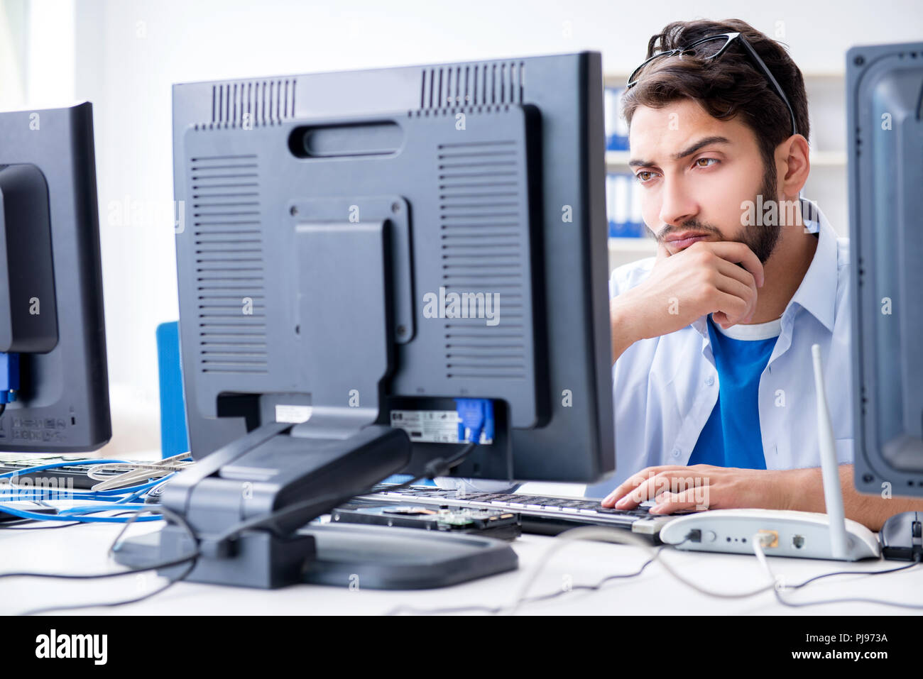 Security man looking at monitors hi-res stock photography and images ...