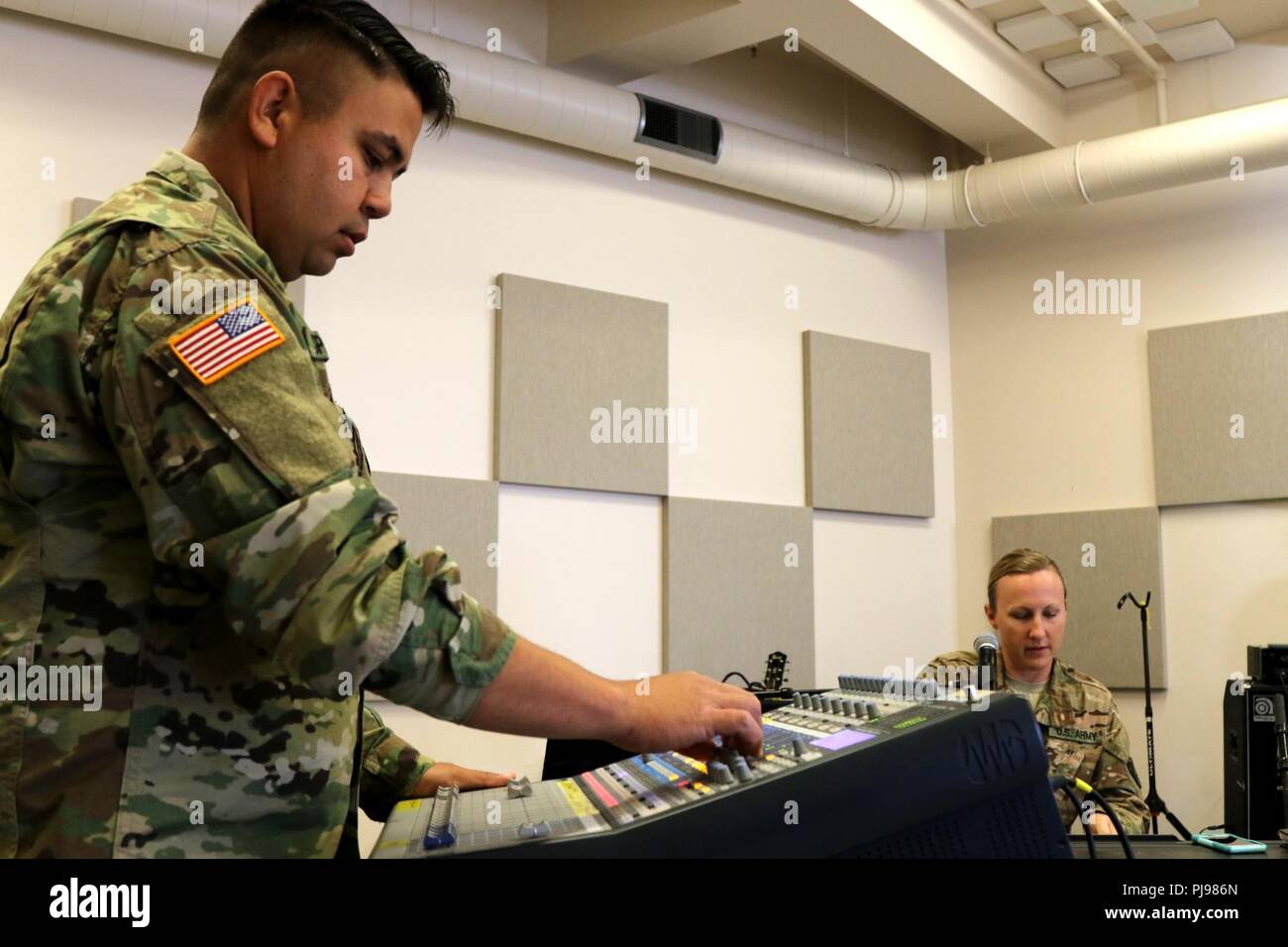 Staff Sgt. James Sposato prepares the audio mixes for the performance ...