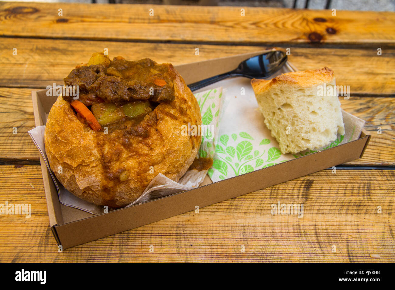 Large bread roll filled with beef goulash, street food in Budapest ...