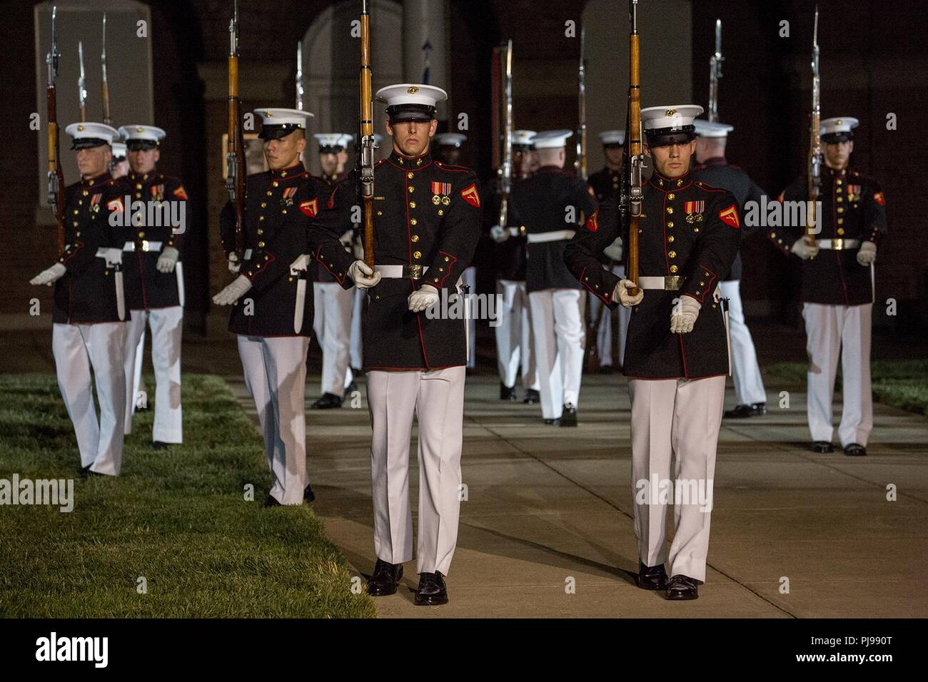 Marines with the U.S. Marine Corps Silent Drill Platoon execute a ...