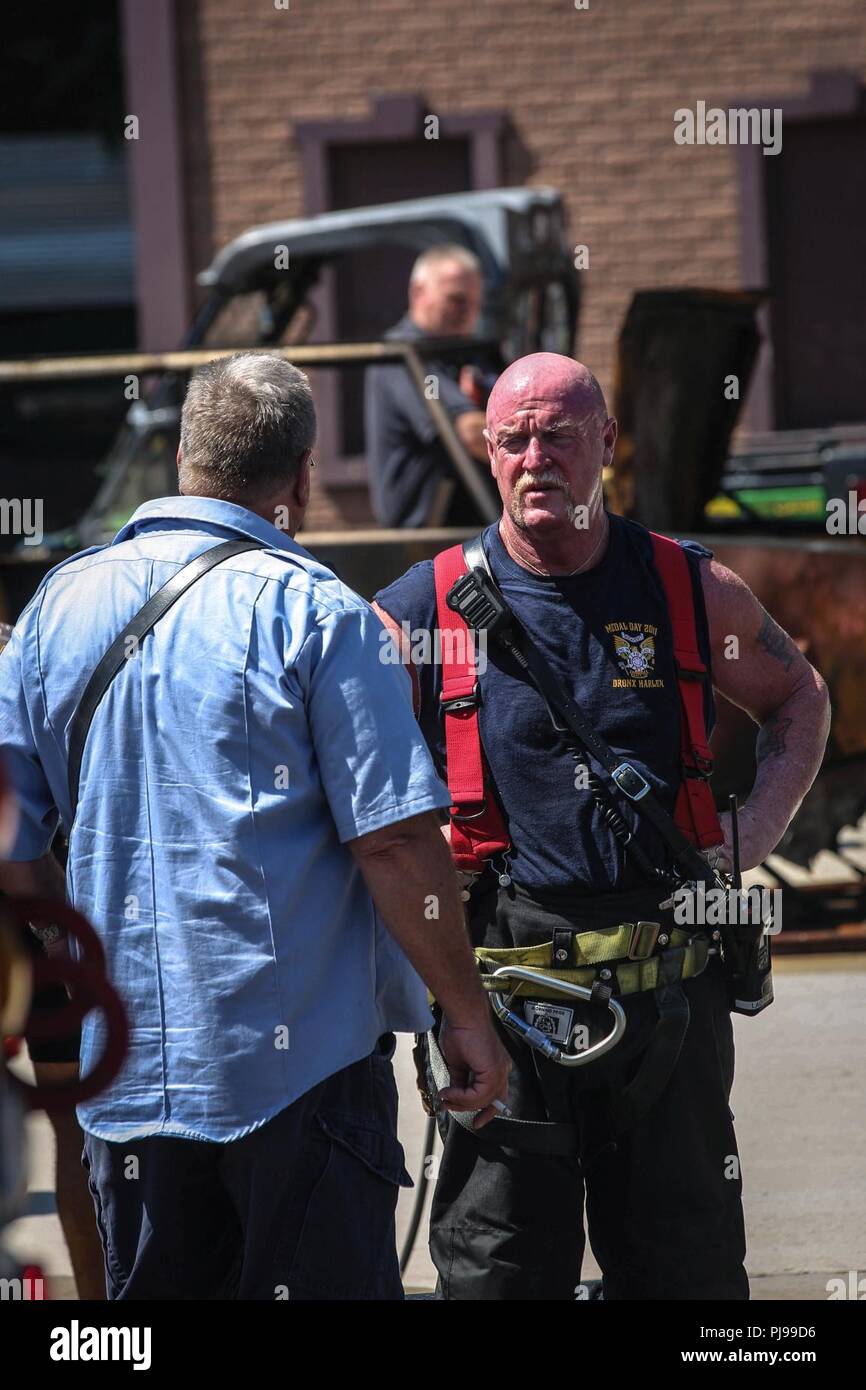 Firefighters from the Fire Department Training Division talk after a ...