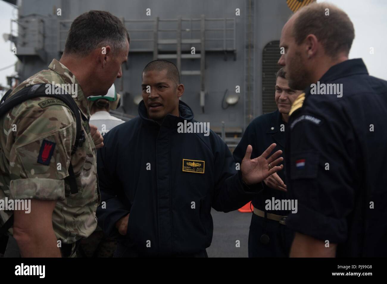 PACIFIC OCEAN (July 9, 2018) Cmdr. G. J. Alota, center, the commanding ...