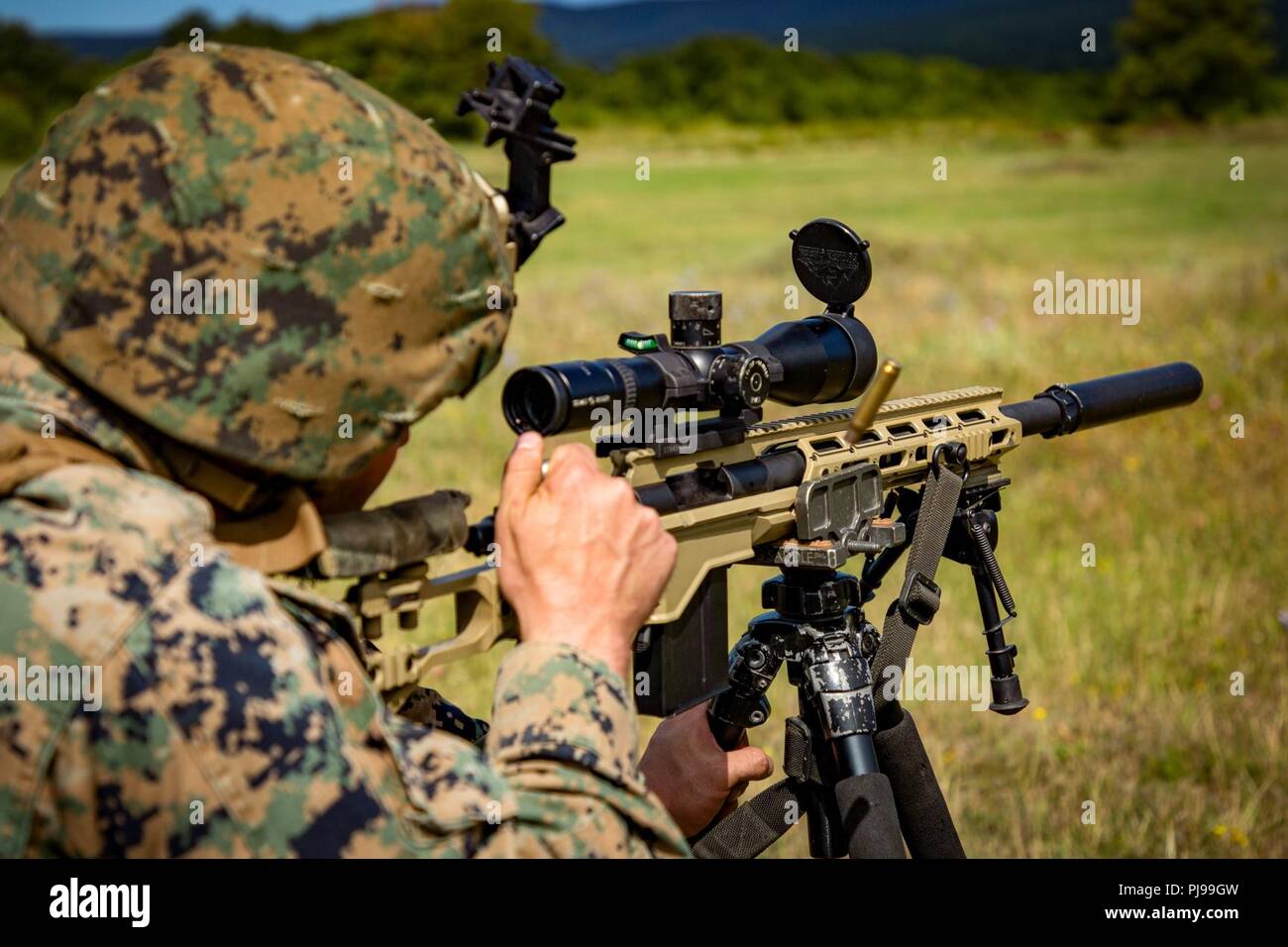A U.S. Marine with Black Sea Rotational Force 18.1 cycles the bolt of ...