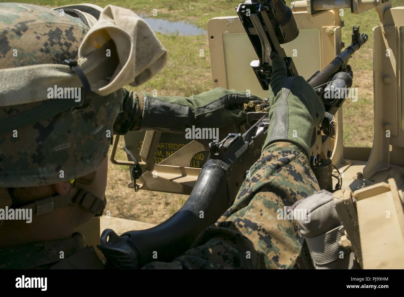 A U.S. Marine with Black Sea Rotational Force 18.1 loads 7.62mm rounds ...