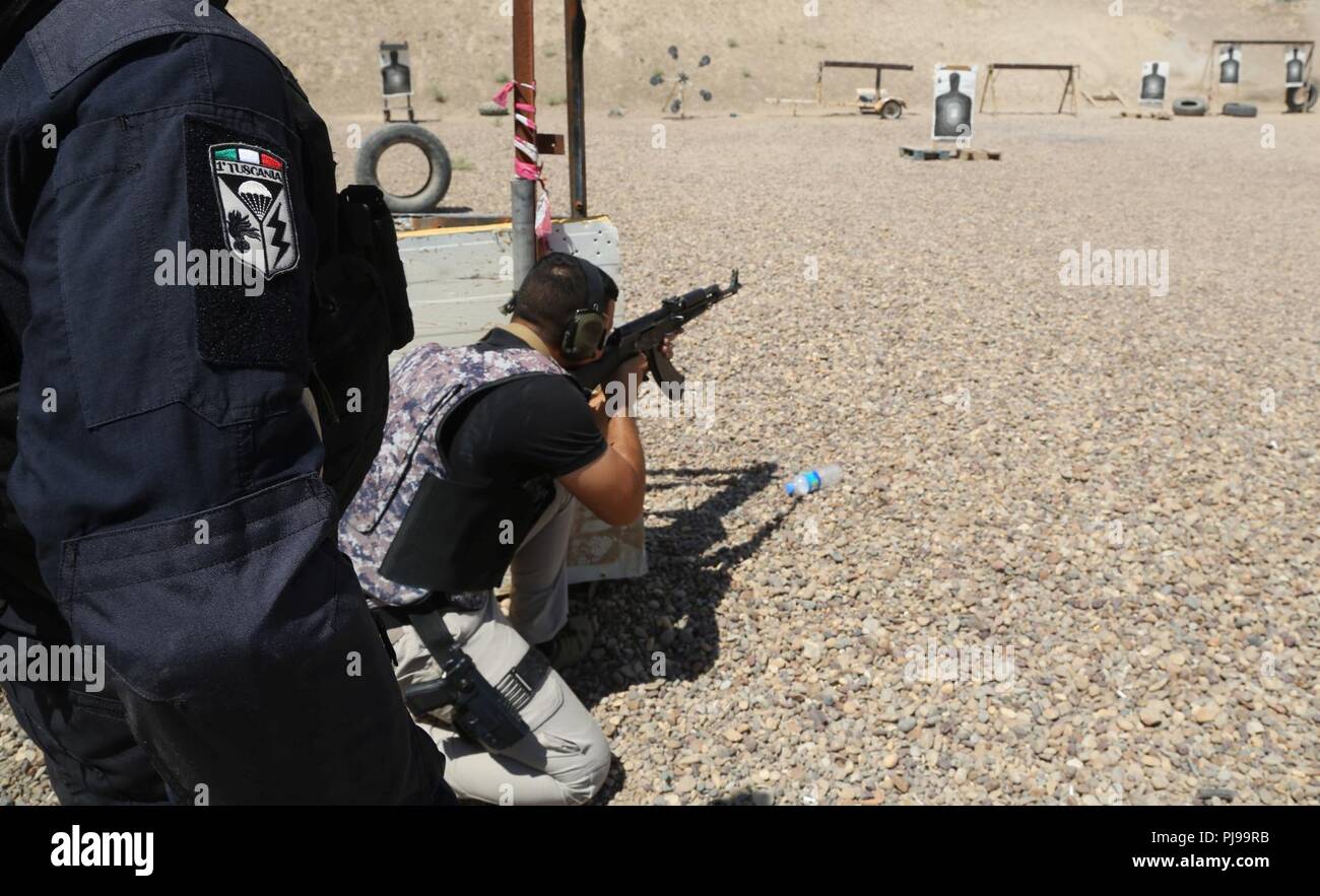 An Iraqi member with the Federal Police fires his AK47 rifle during a ...
