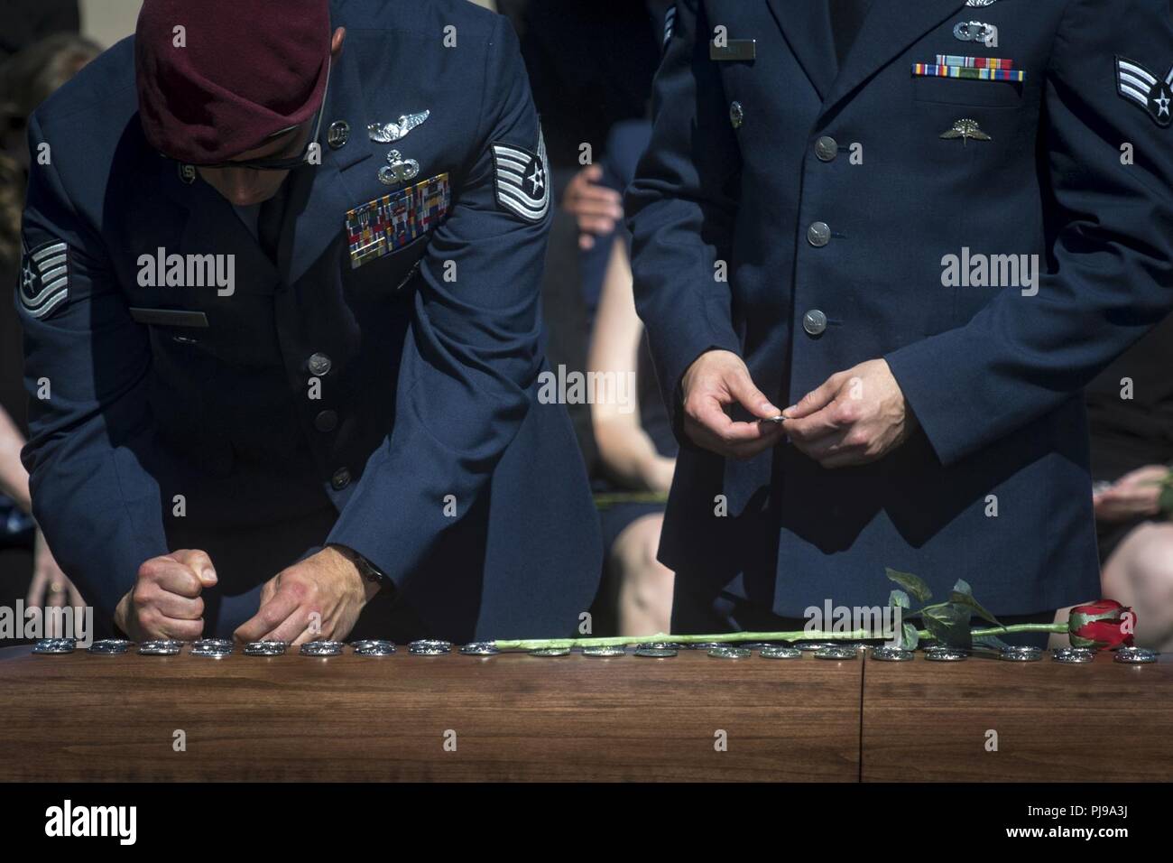 Pararescuemen pound their beret flashes into Capt. Mark Weber’s casket ...