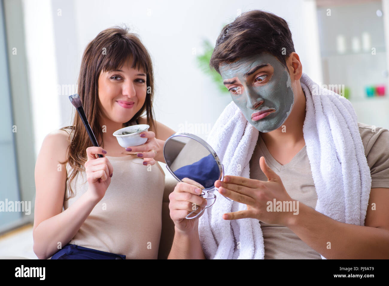 Handsome applying clay mask on face Stock Photo - Alamy