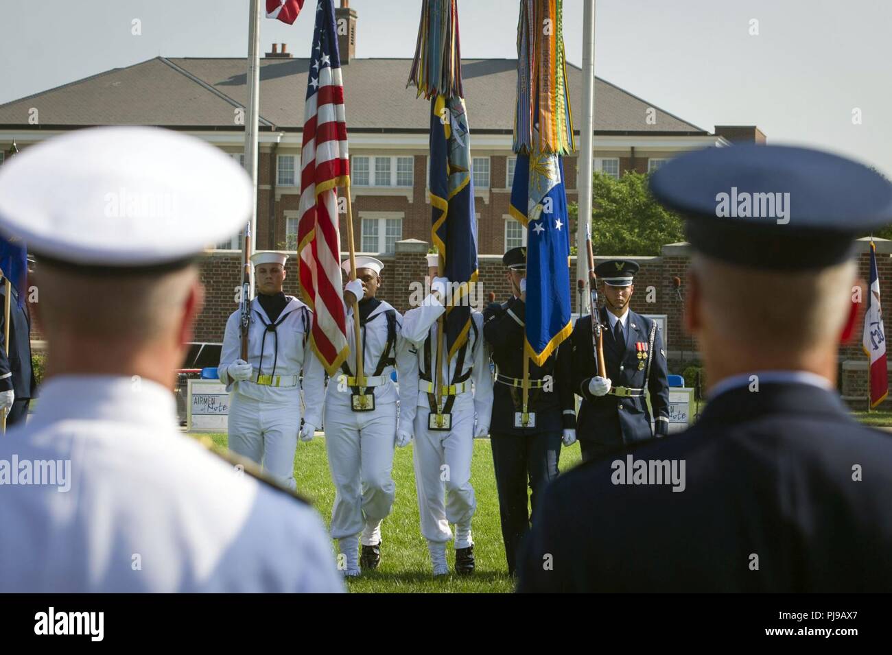 A joint U.S. Air Force and Navy colorguard present the colors during ...