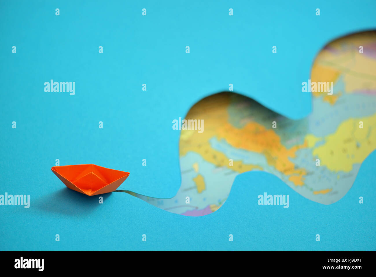 Paper boat making waves on a background map of the world Stock Photo ...