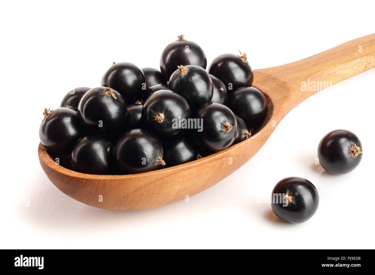 black currant heap in wooden spoon isolated on white background Stock ...