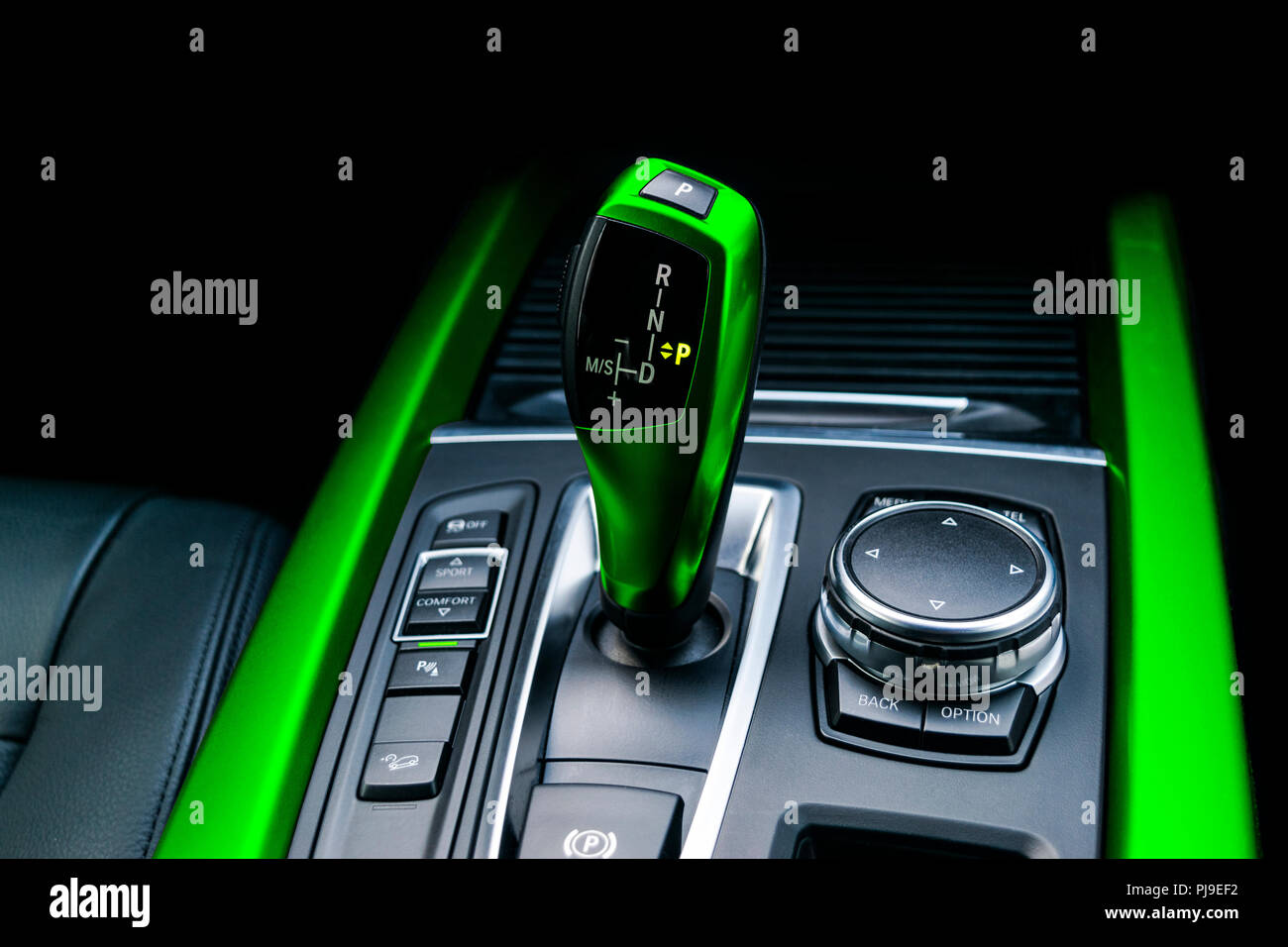 Green Automatic gear stick of a modern car. Maodern car interior details. Close up view. Car ...
