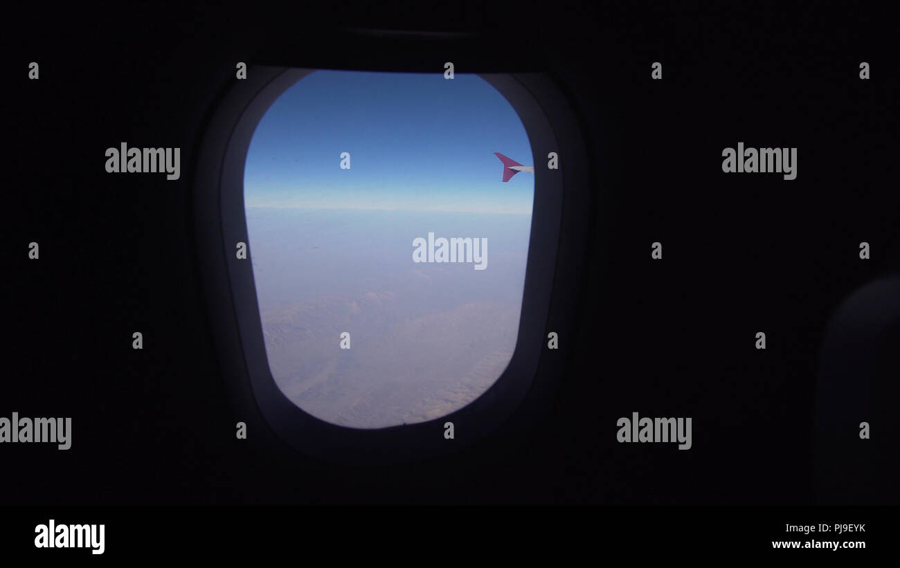 Mountain range from the airplane window. Airplane wing. Aerial view on ...