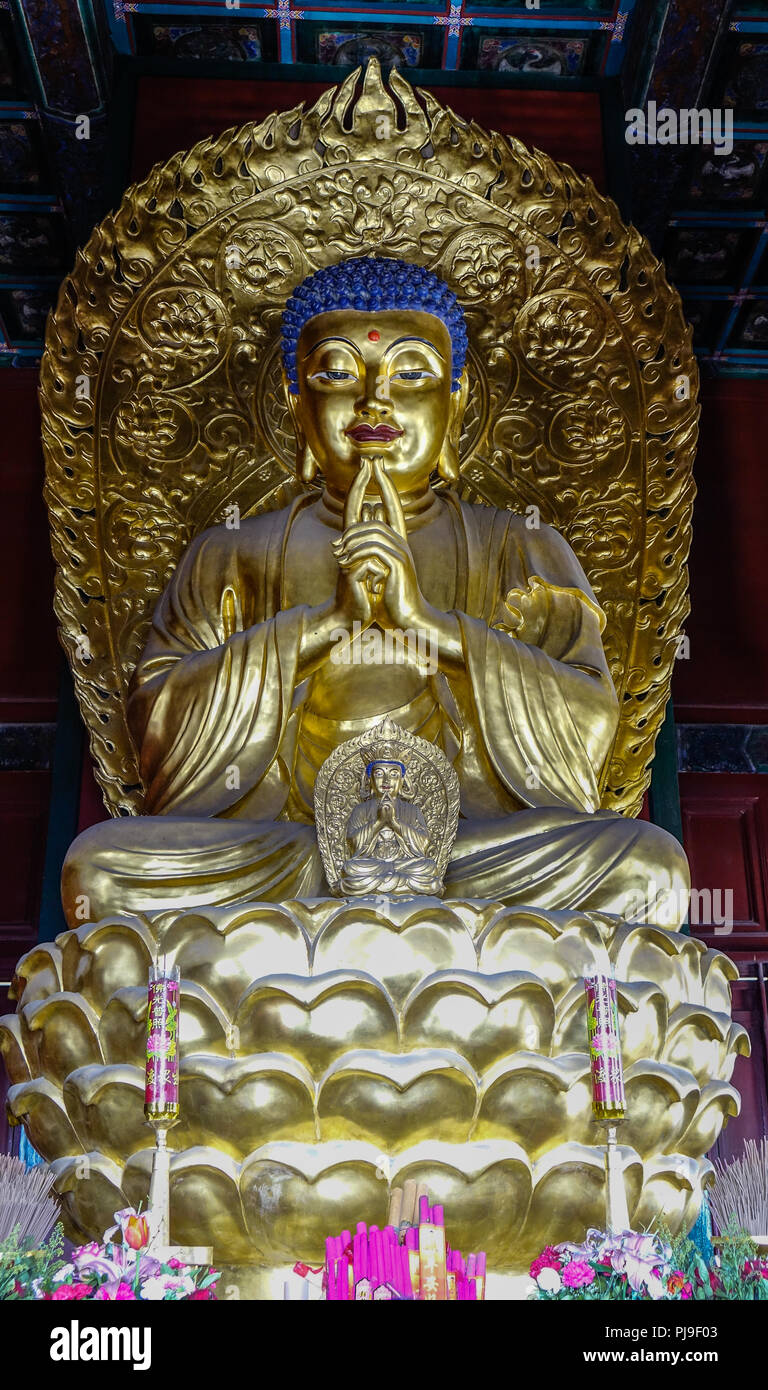 Beijing, China - Mar 1, 2018. A golden Buddha statue at old pagoda in ...